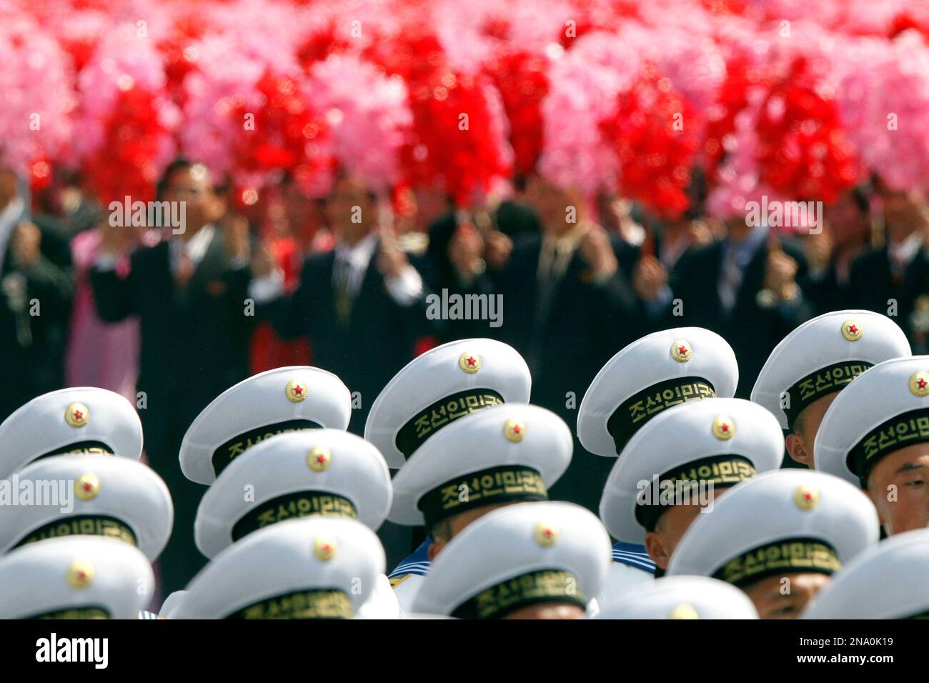 North Korean soldiers and residents take part in a mass military parade ...