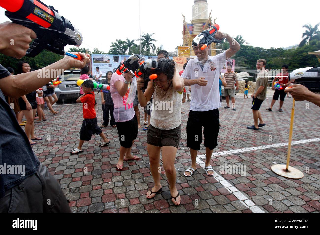 People shoot each other with water guns as they celebrate the Songkran festival, the Thai ...