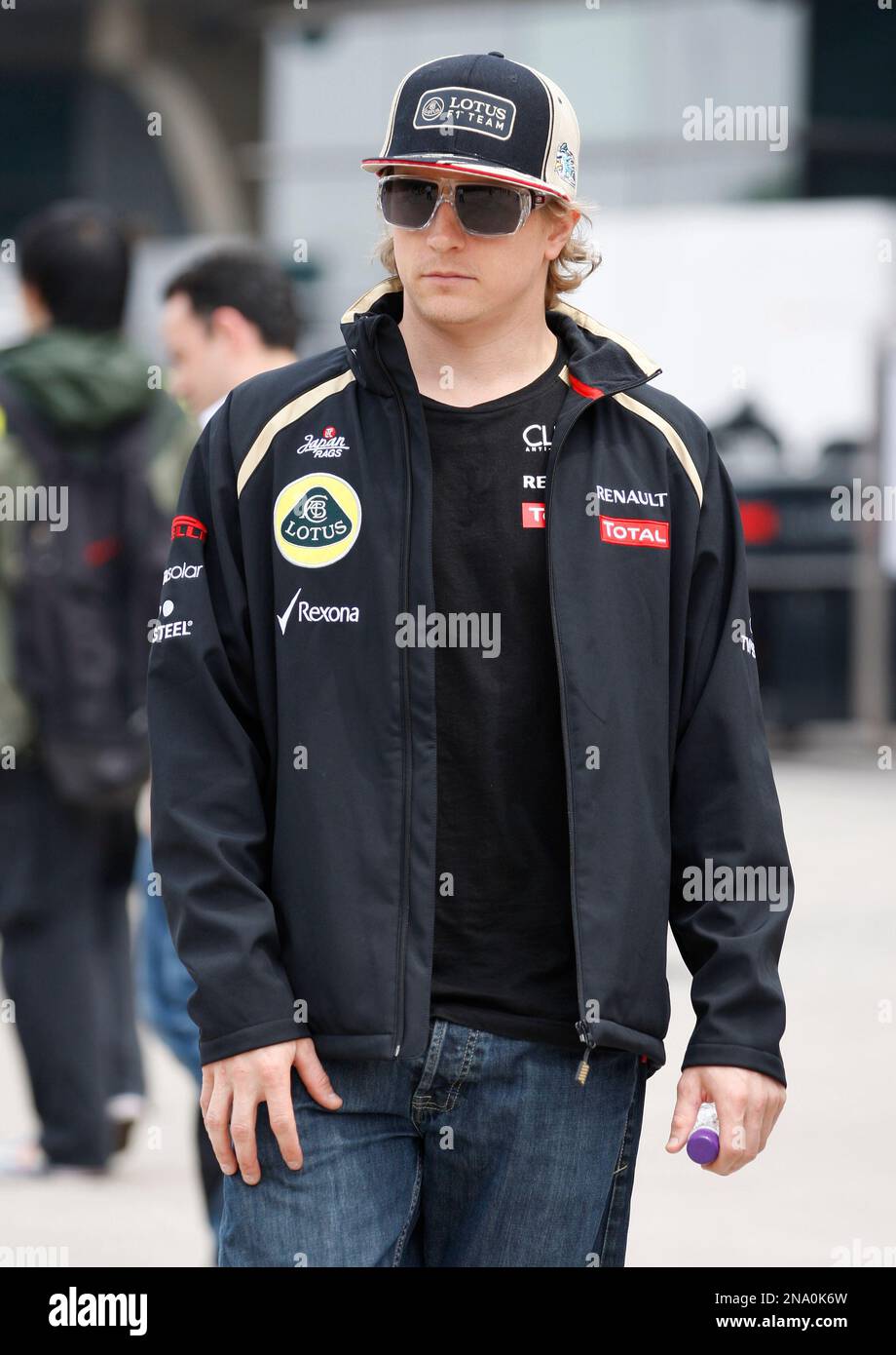 Lotus Formula One driver Kimi Raikkonen of Finland walks down the F1 ...