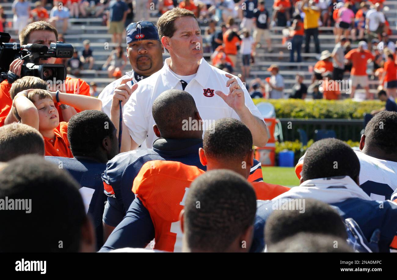 Auburn coach Gene Chizik talks with his players during their annual ...
