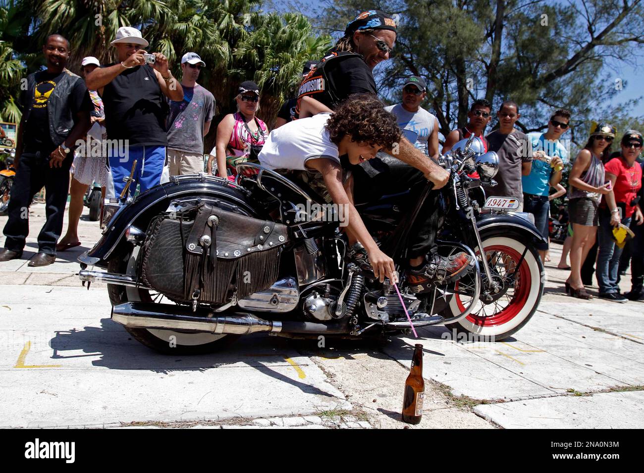 Bikers participate in the competition to place a single straw into ...