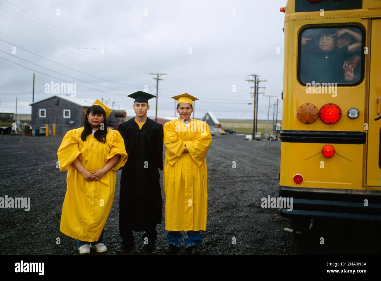 Inuit teens in graduation gowns pose for a portrait; North Slope ...