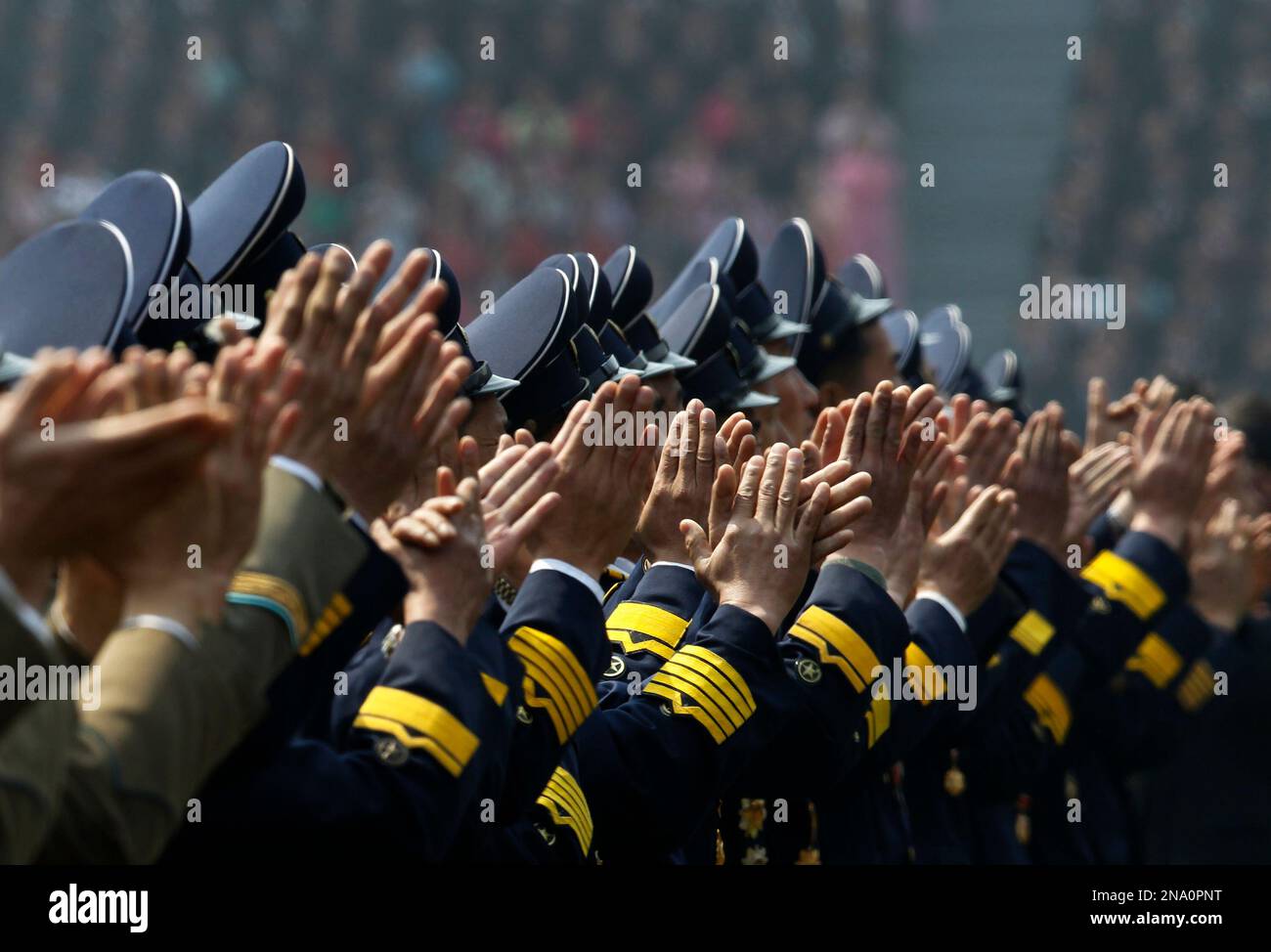 A crowd of North Korean military members clap hands at a stadium during ...