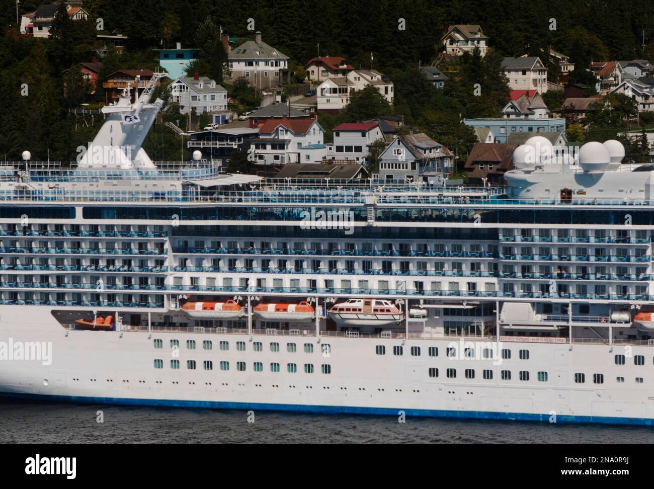 Cruise ship docked at Ketchikan Harbor dwarfs houses on hillside ...
