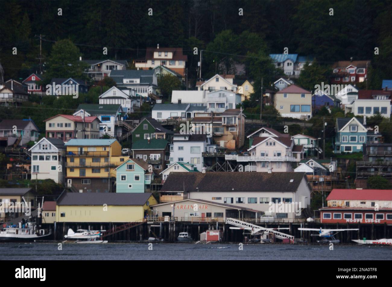 Houses built above Ketchikan Harbor where many cruise ships dock ...