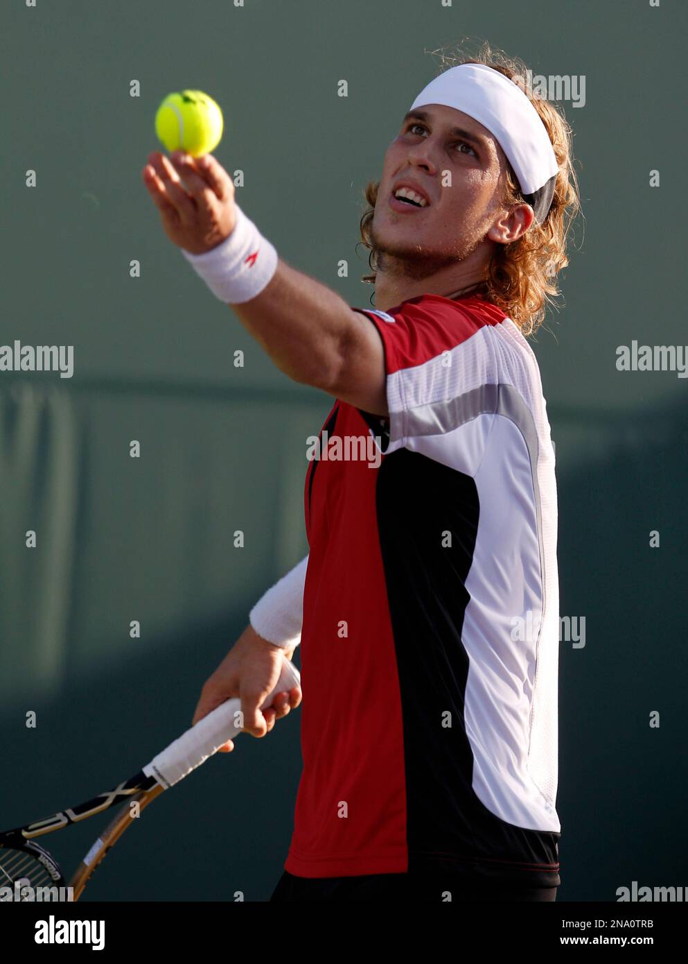Lukas Lacko of Slovakia, returns the ball to Kei Nishikori of Japan ...