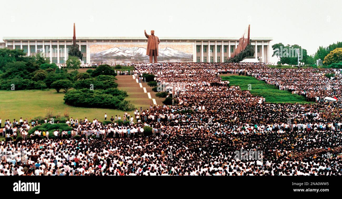 Crowds pack Pyongyang’s Mansu Hill in front of the toweringstatue of ...