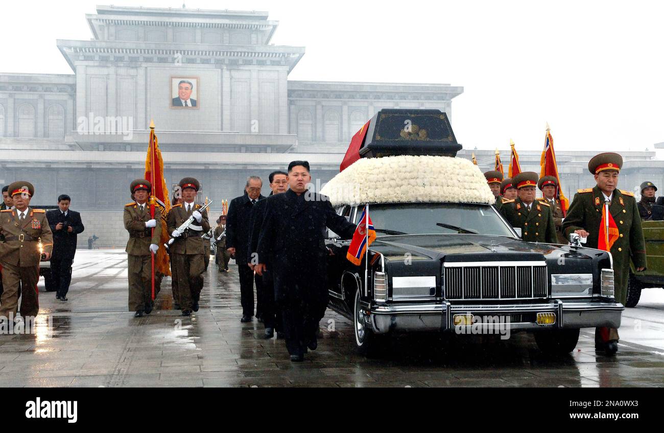DPRK leader Kim Jong Un stands alongside a hearse carrying hisfather ...