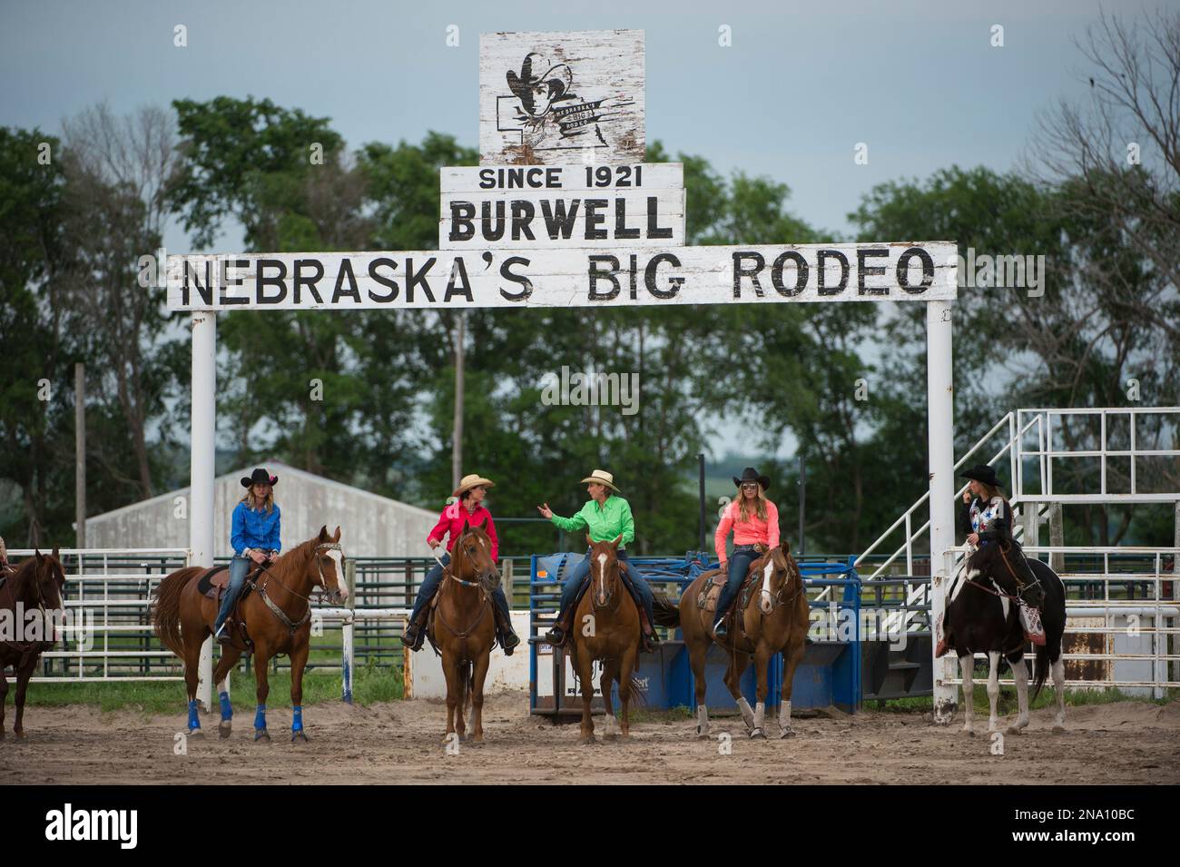 Rodeo queens on horses stand at the rodeo entrance gates; Burwell ...