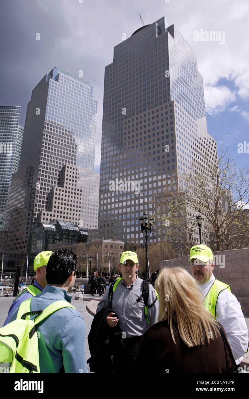 A evacuation team confers outside 2 World Financial Center, right, in ...