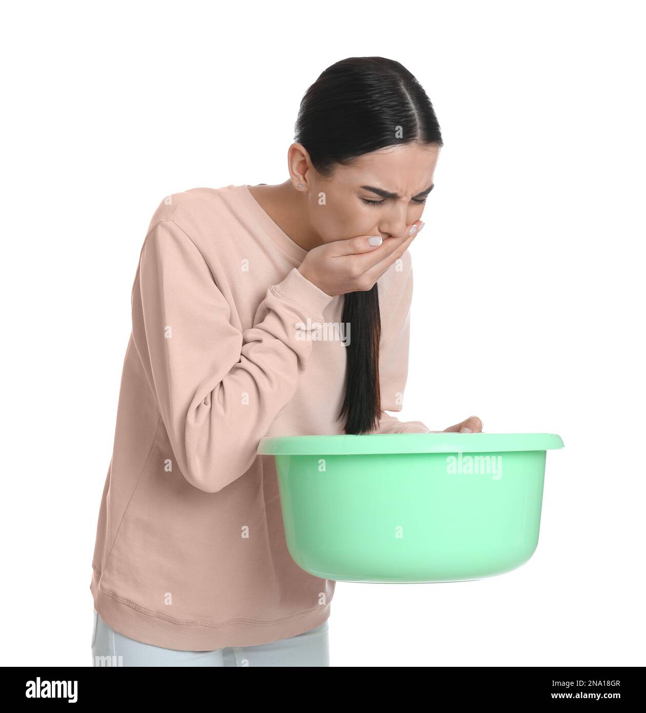 Woman with basin suffering from nausea on white background. Food ...