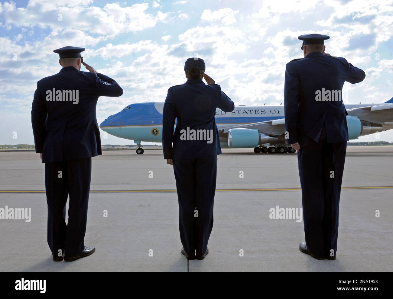 An Air Force greeting party salute Air Force One as it prepares to take ...