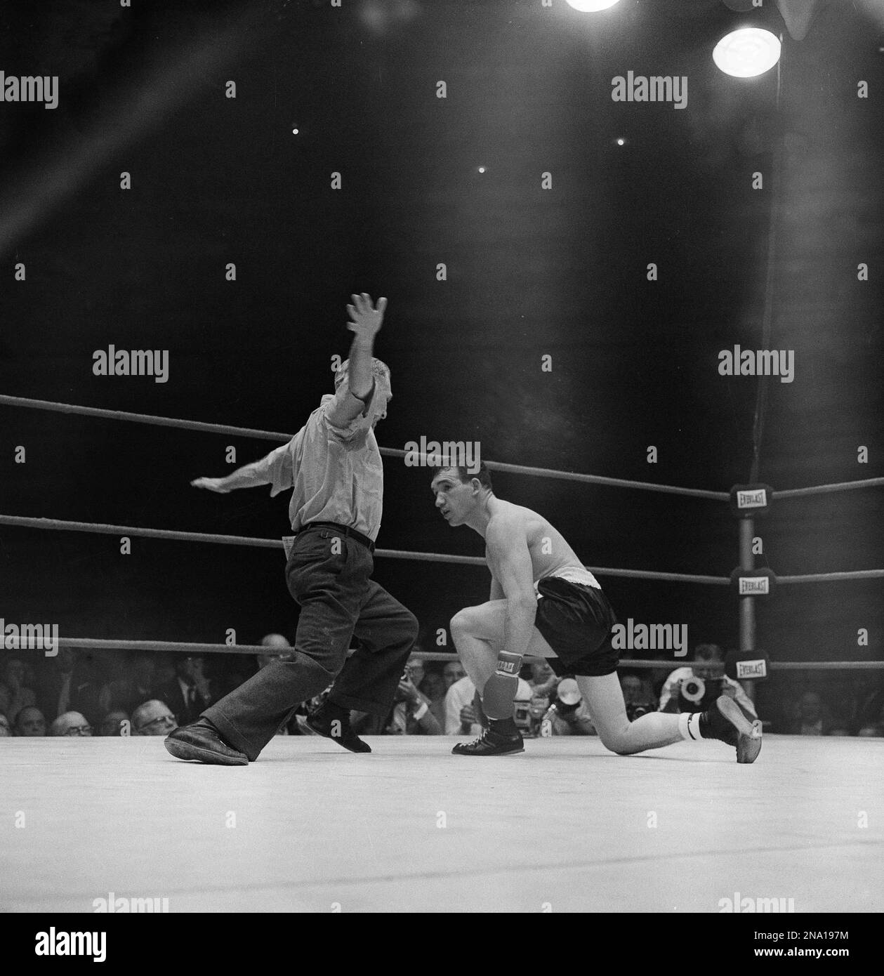 Referee Frank Sikora stretches his arms to signify the fight is over ...