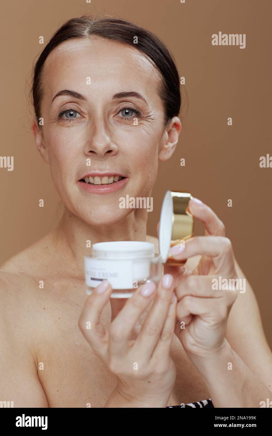 Portrait Of Modern 40 Years Old Woman With Facial Cream Jar Isolated On