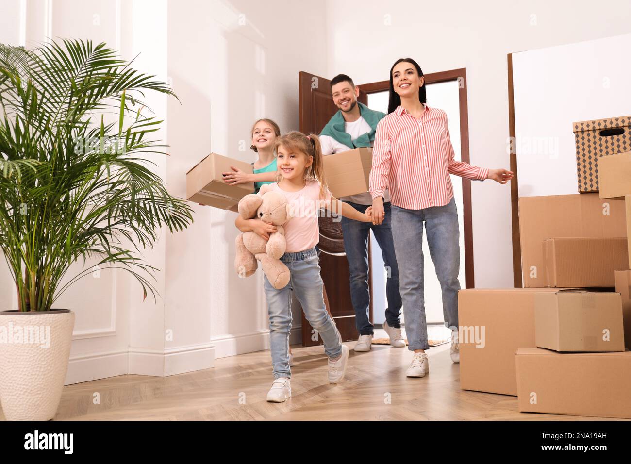 Happy family with children moving into new house Stock Photo - Alamy