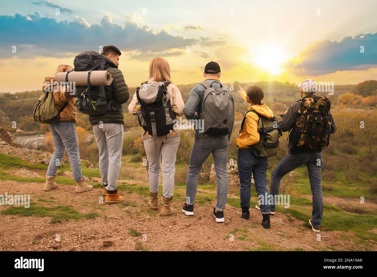 Group of hikers with backpacks in mountains, back view Stock Photo - Alamy