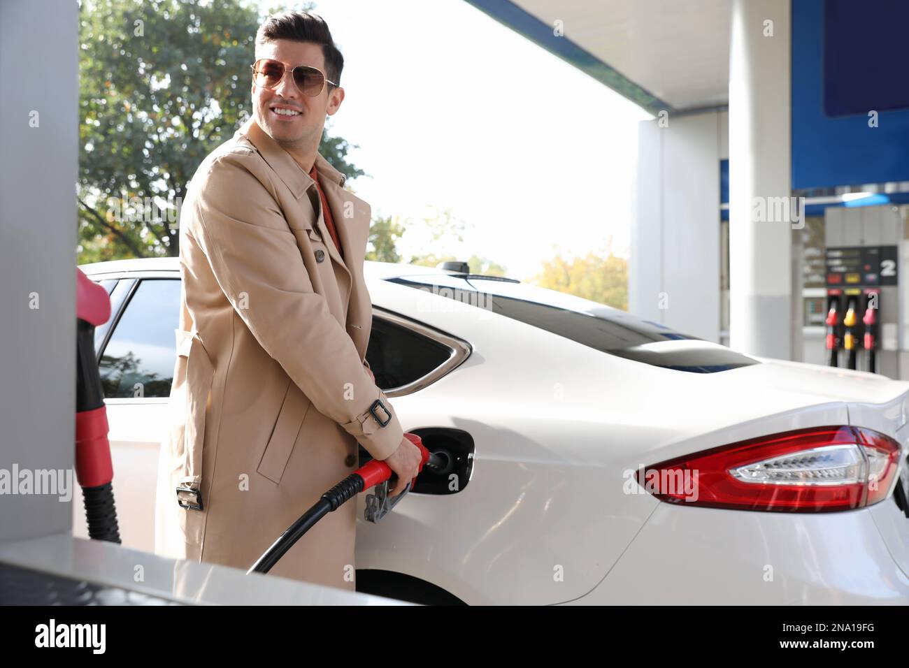 Man refueling car at self service gas station Stock Photo - Alamy
