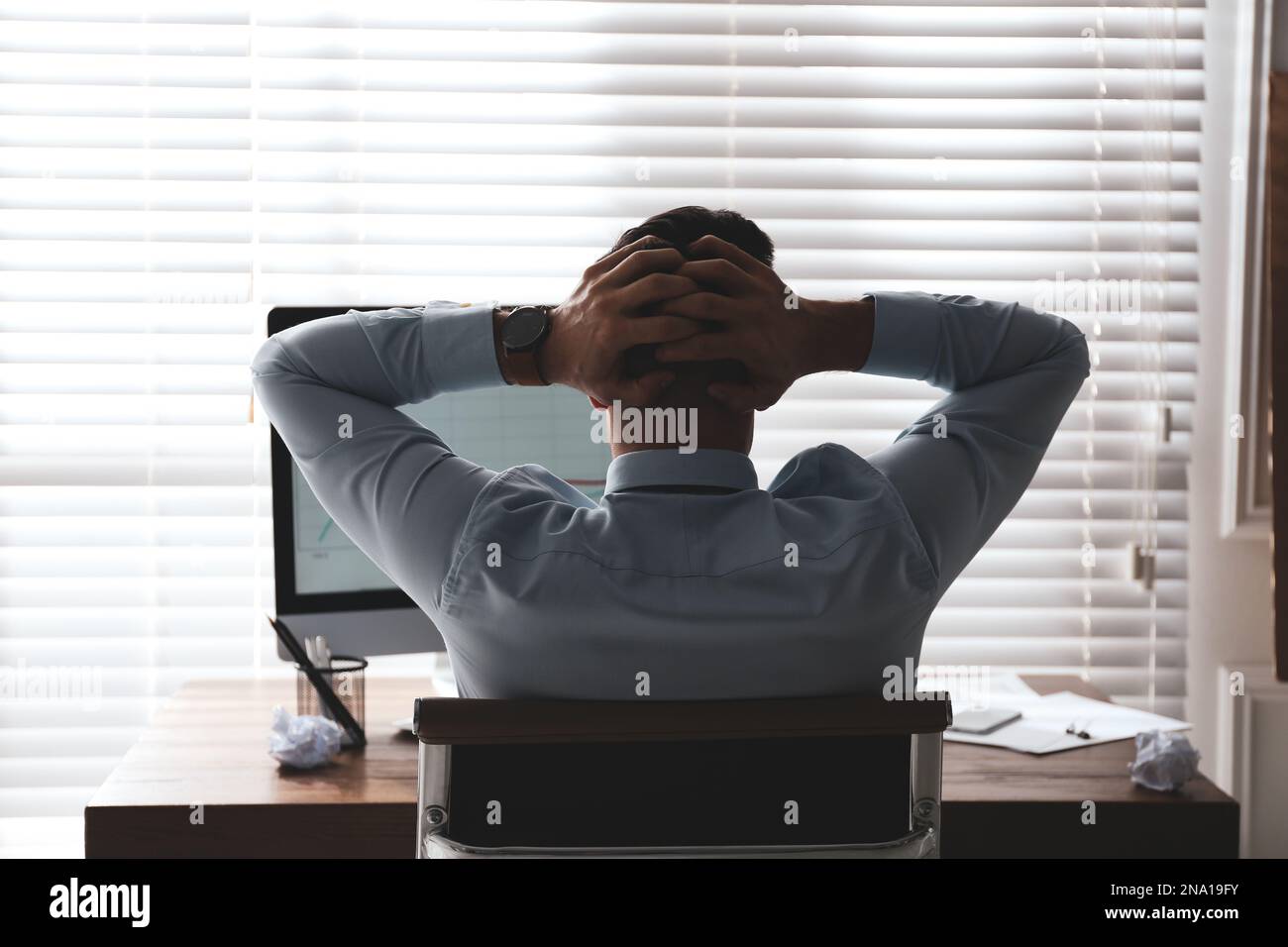 Businessman stressing out at workplace in office, back view Stock Photo ...