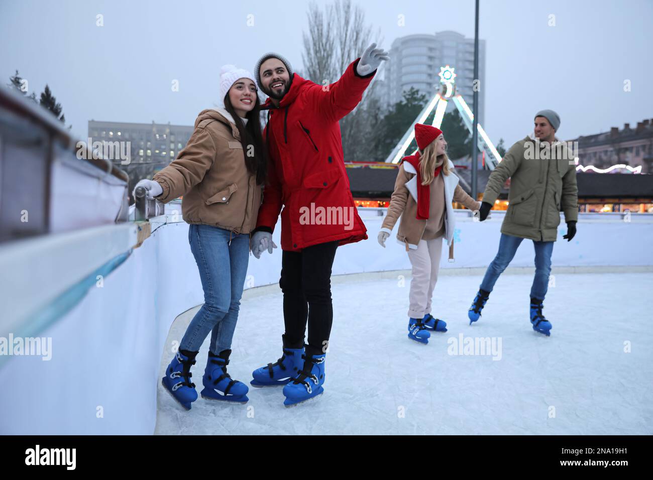 Group of friends at outdoor ice skating rink Stock Photo - Alamy