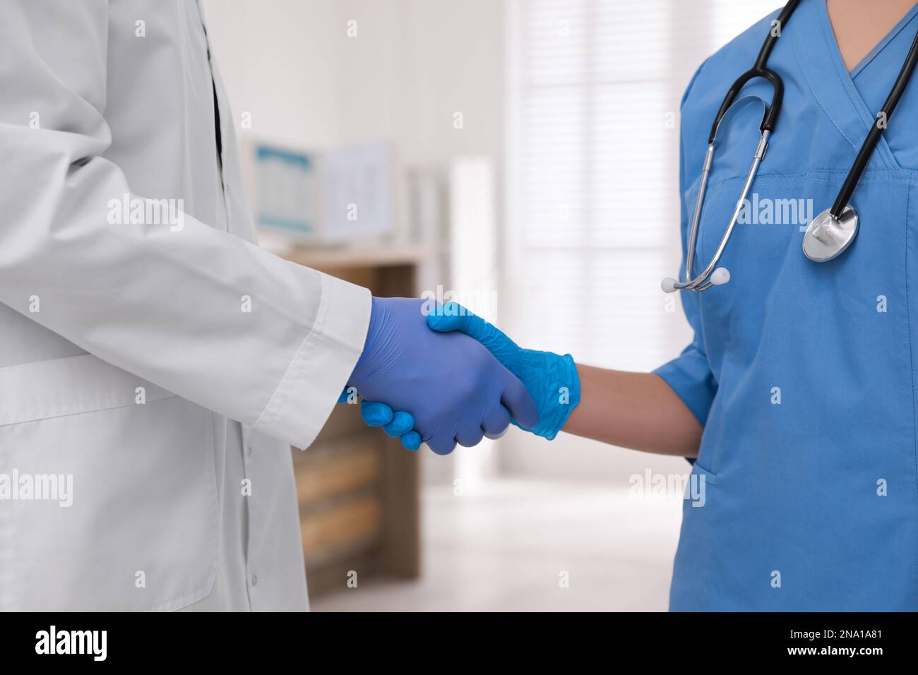 Surgical gloves handshake hi-res stock photography and images - Alamy