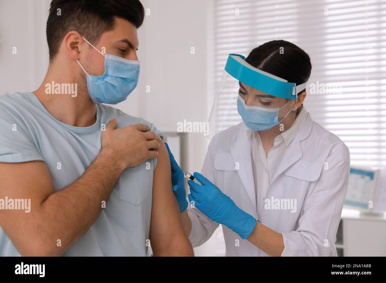 Doctor giving injection to patient in hospital. Vaccination campaign ...