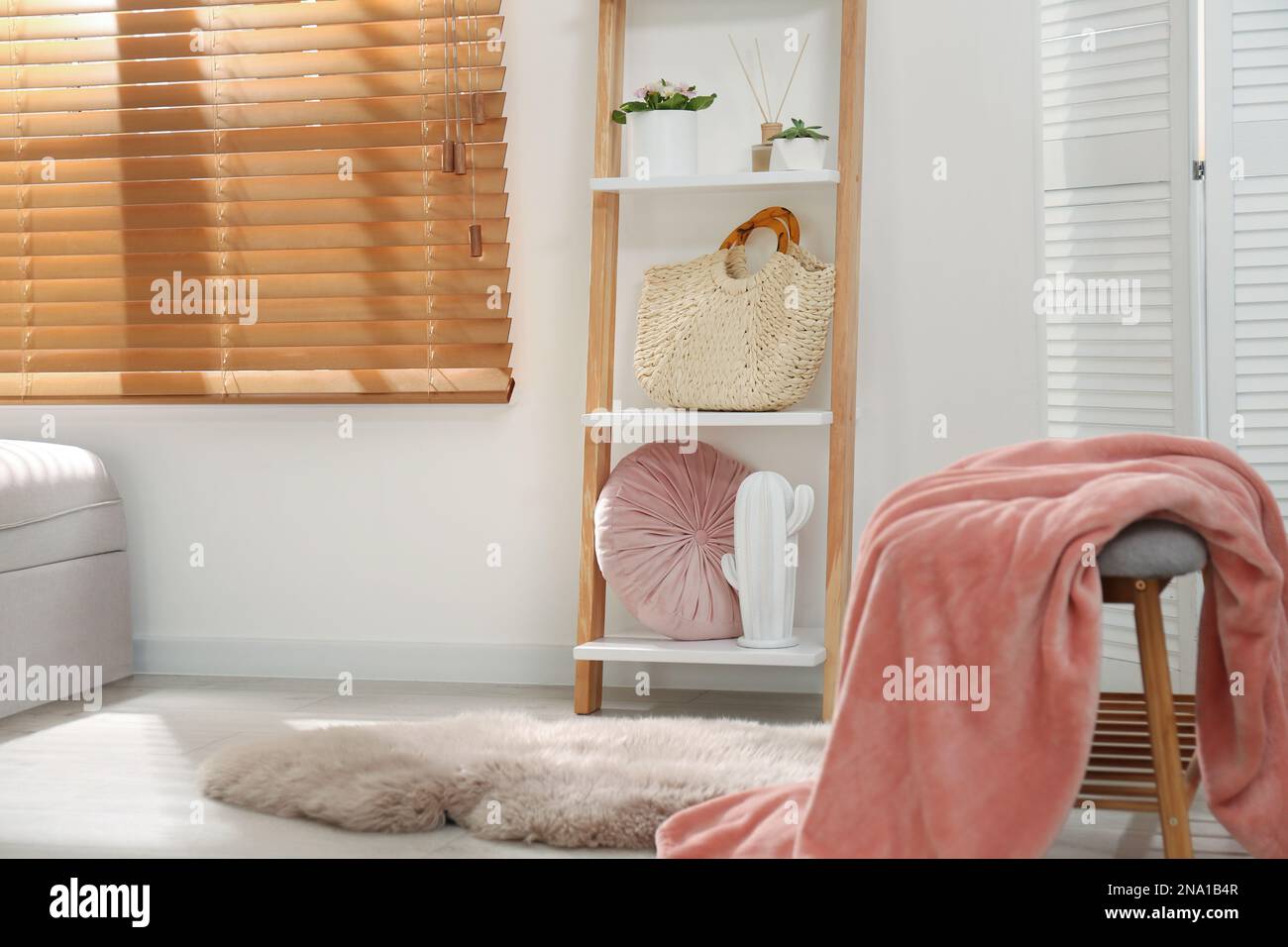 Stylish room interior with wooden ladder near white wall Stock Photo ...