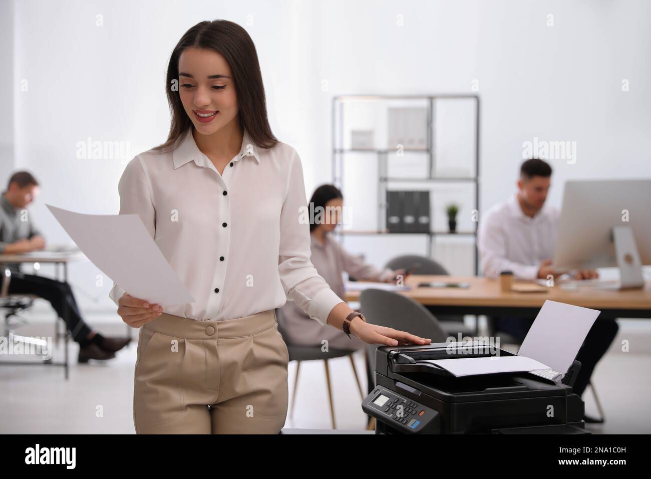 Employee using new modern printer in office Stock Photo - Alamy