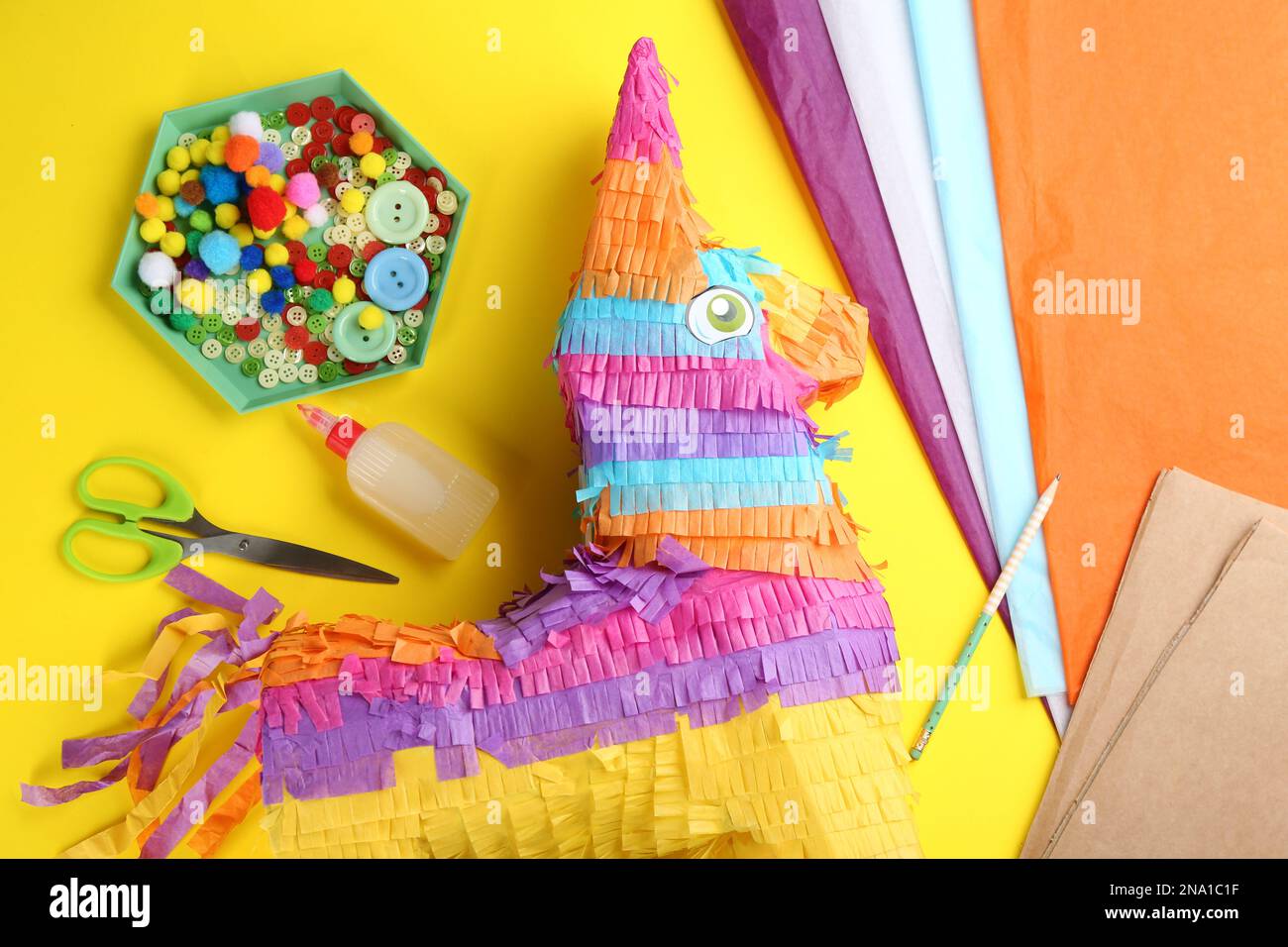 Flat lay composition with cardboard donkey and materials on yellow ...