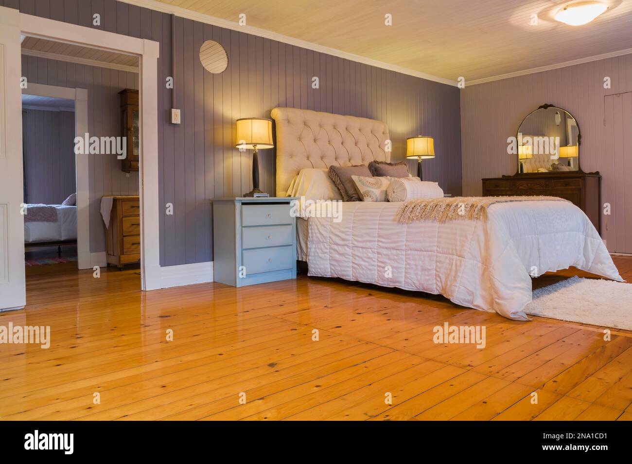 Queen size bed with white bedspread, beige cloth headboard, light blue ...