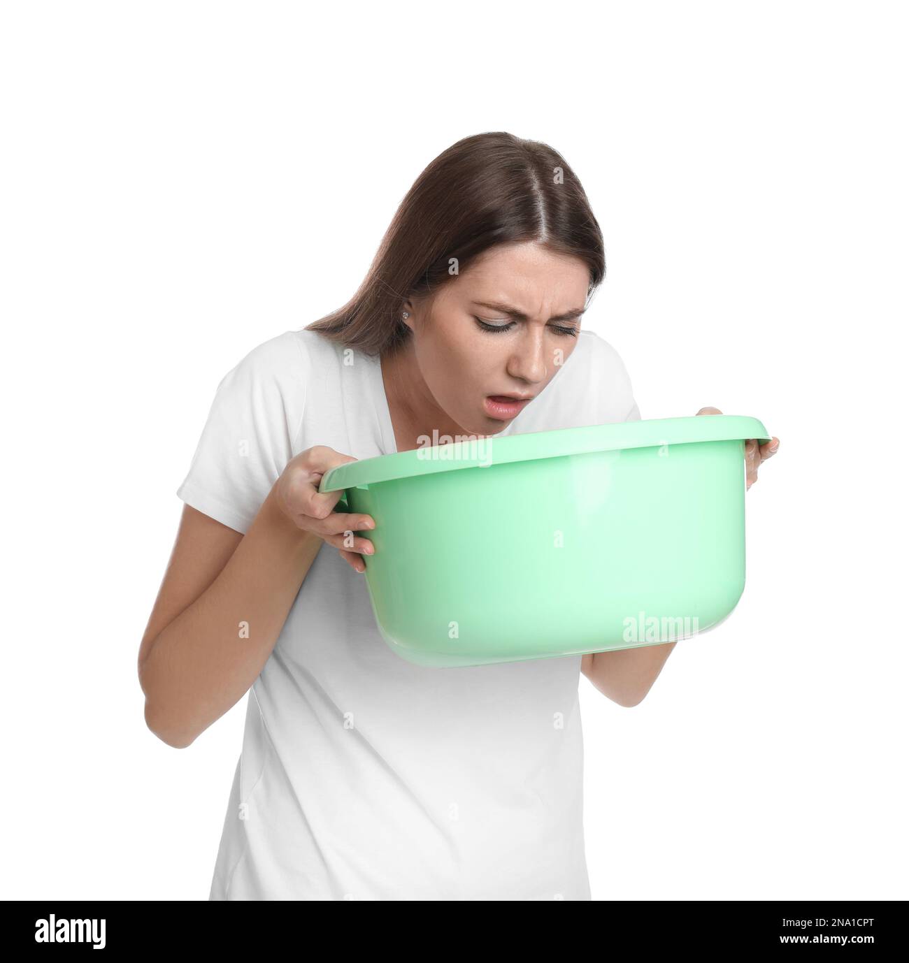 Woman with basin suffering from nausea on white background. Food ...