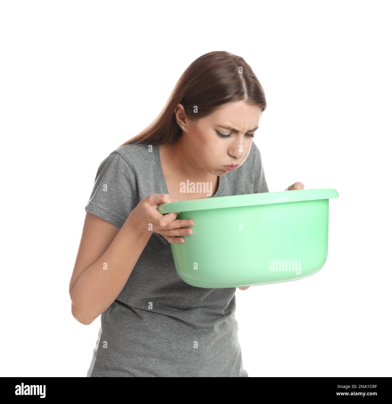 Woman with basin suffering from nausea on white background. Food ...
