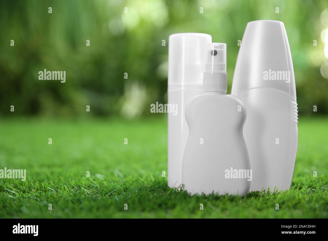Different insect repellents on green grass. Space for text Stock Photo ...