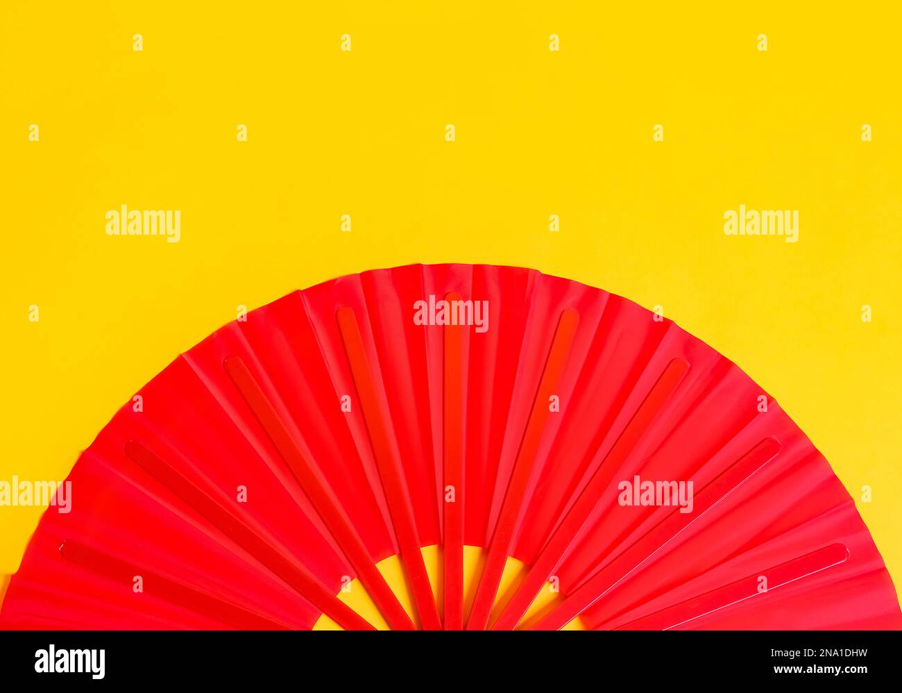Red hand fan on yellow background, top view Stock Photo - Alamy