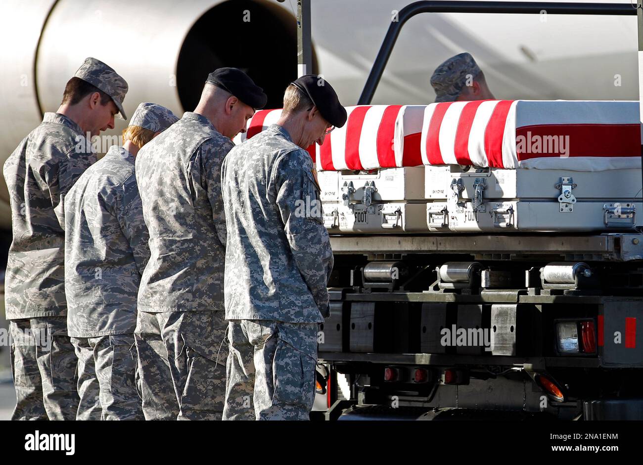 Chaplain Maj. Marty Fields, left, direct a prayer over the transfer ...