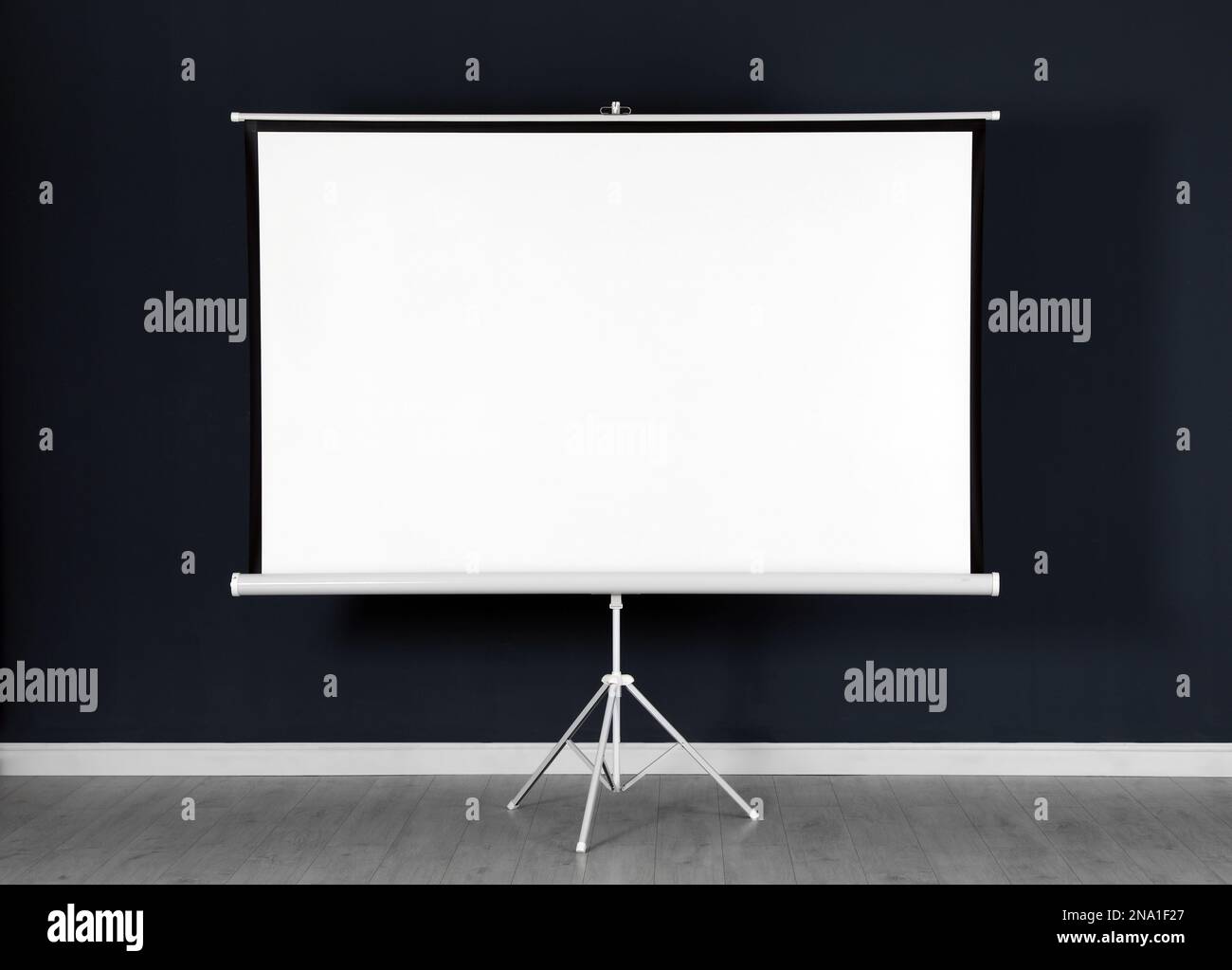 Blank projection screen near black wall indoors. Space for design Stock ...