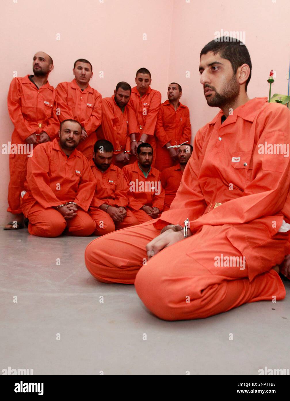 Handcuffed suspects seen in the federal police headquarters in Baghdad ...