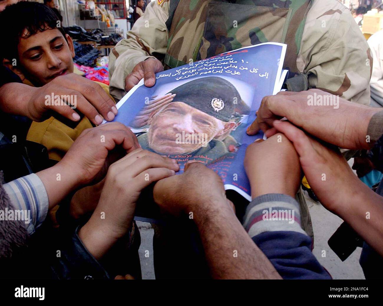 FILE - In this Sunday, Jan. 4, 2004 file photo, Iraqi children surround ...