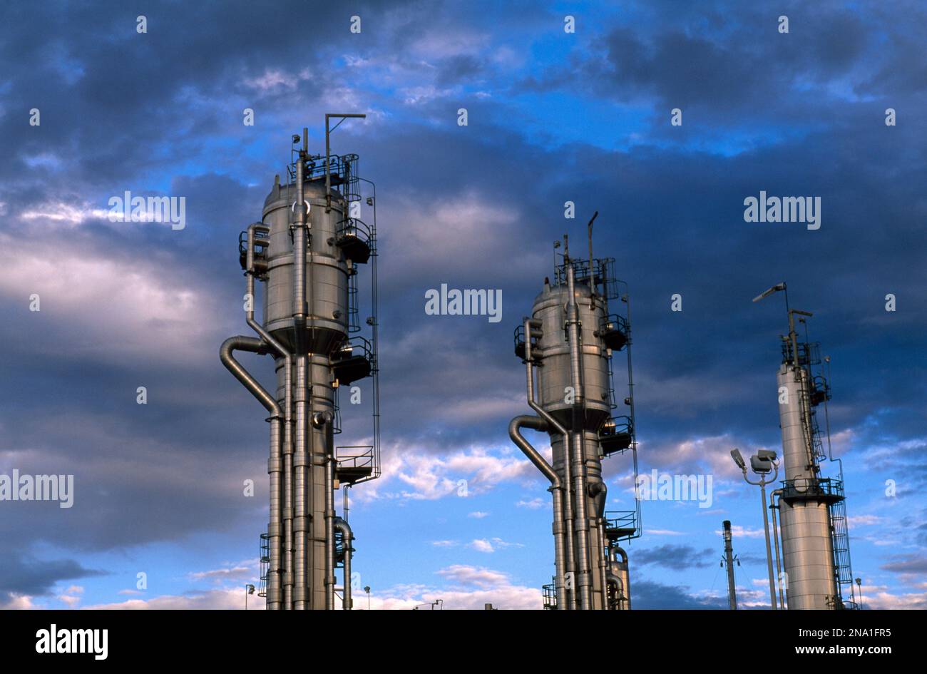 Natural gas rigs against a dramatic sky; Bloomfield, New Mexico, United ...