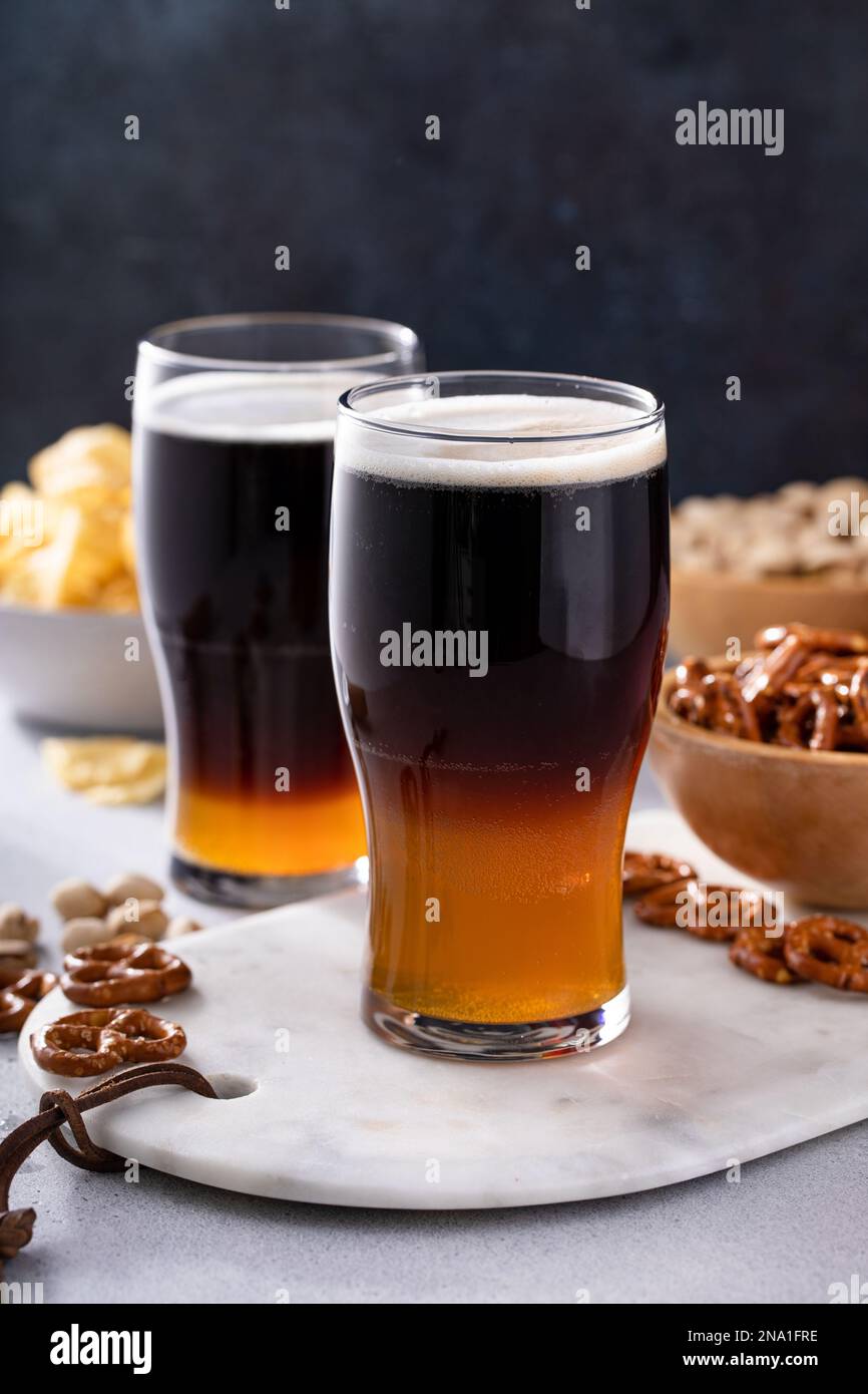 Half and half beer cocktail with lager and dark stout in a beer glass ...