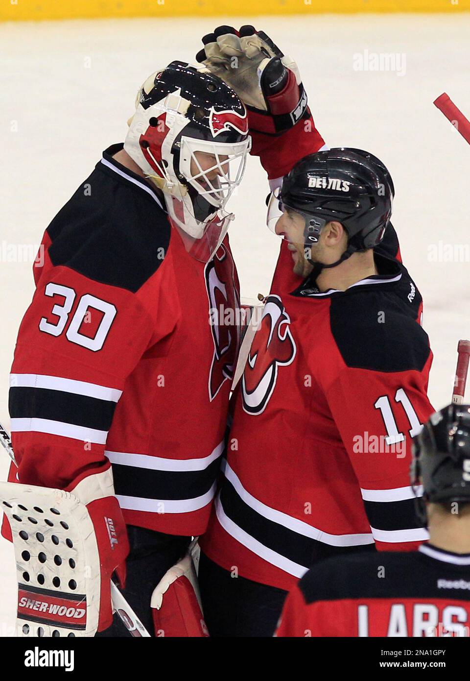 New Jersey Devils' Stephen Gionta, right, celebrates with goalie Martin ...