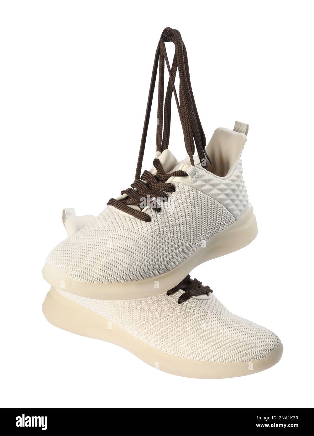 Pair of stylish shoes with laces hanging on white background Stock ...