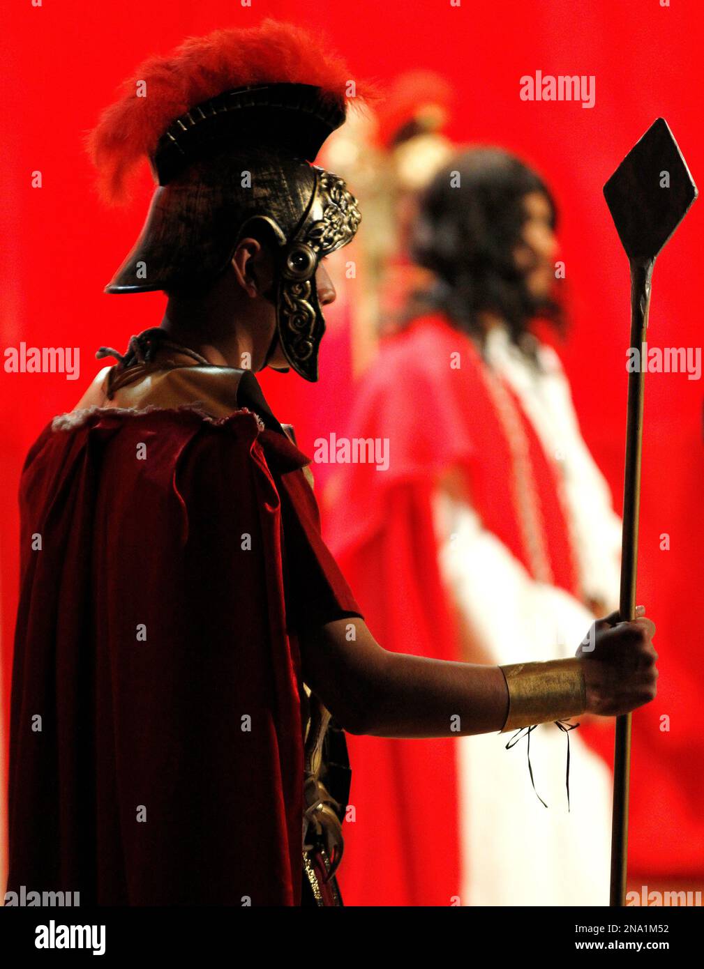 An actor playing the role of a soldier stands guard as David Amador, 26 ...