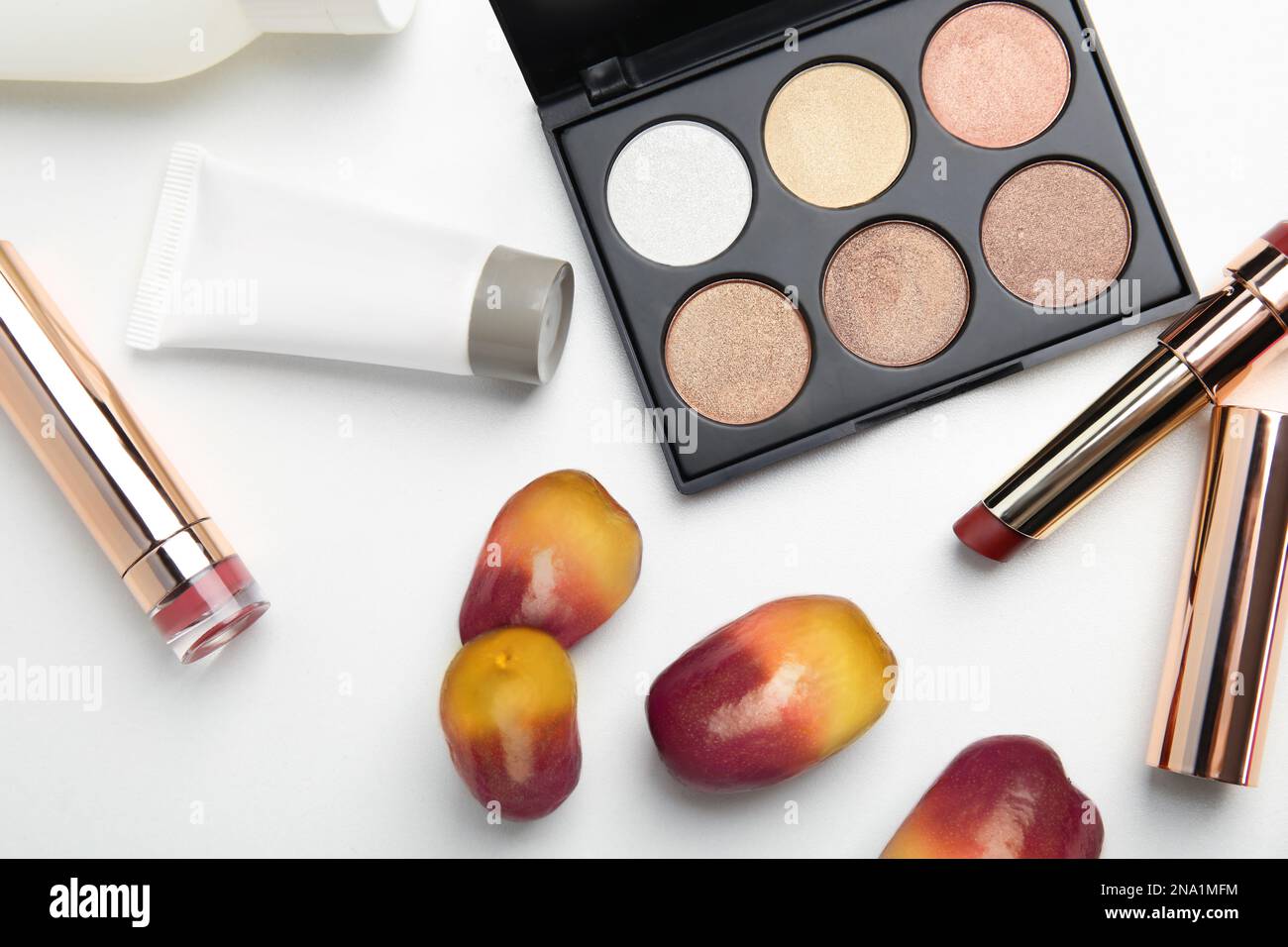 Fresh ripe palm oil fruits and cosmetic products on white background ...