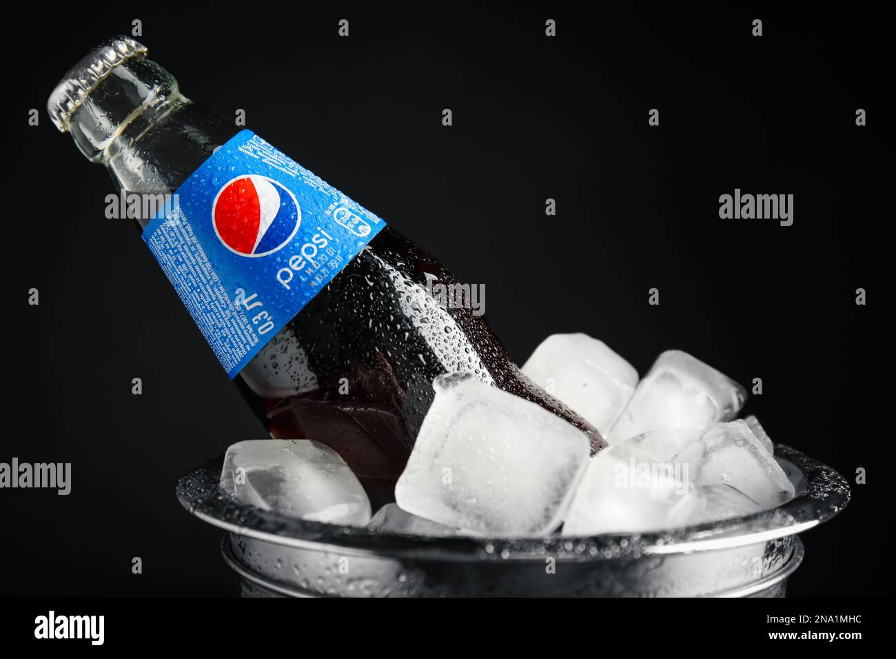 MYKOLAIV, UKRAINE - FEBRUARY 11, 2021: Glass bottle of Pepsi and ice ...