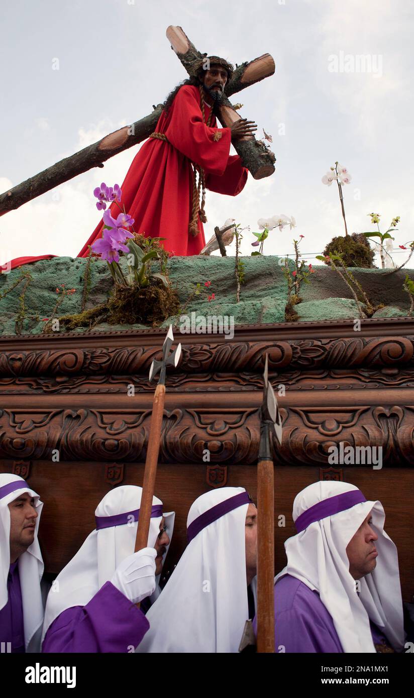 Penitents carry a statue of Jesus during a Holy Week procession on Good ...