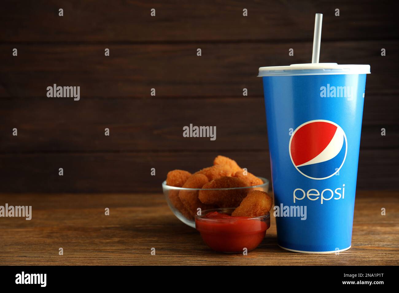MYKOLAIV, UKRAINE - FEBRUARY 16, 2021: Cup of Pepsi, chicken nuggets ...