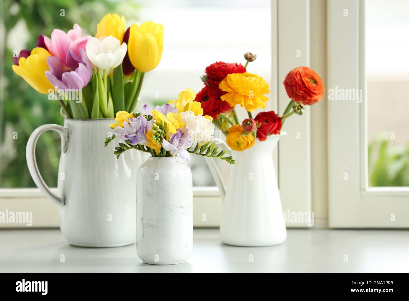 Different beautiful spring flowers on window sill Stock Photo - Alamy
