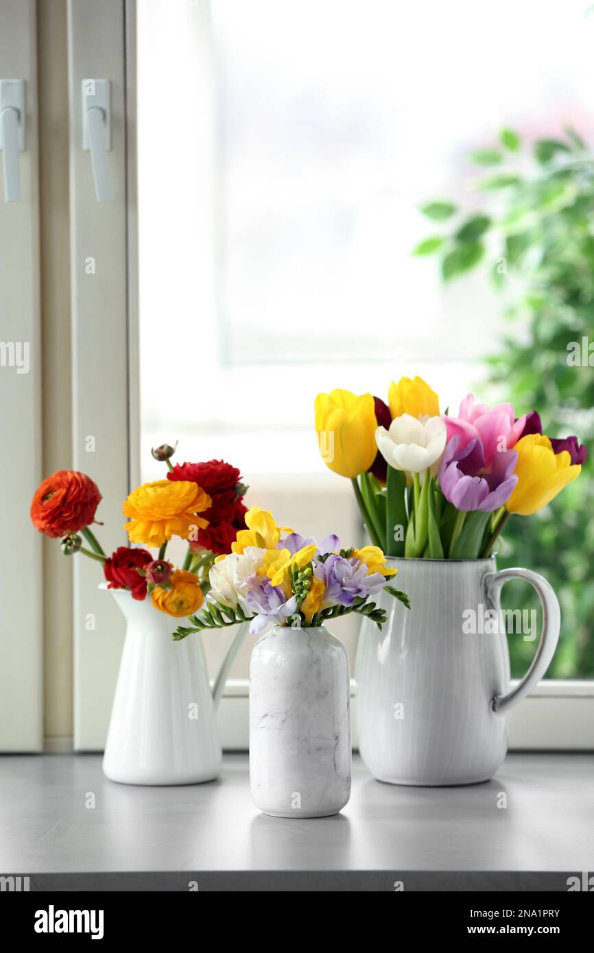 Different beautiful spring flowers on window sill Stock Photo - Alamy