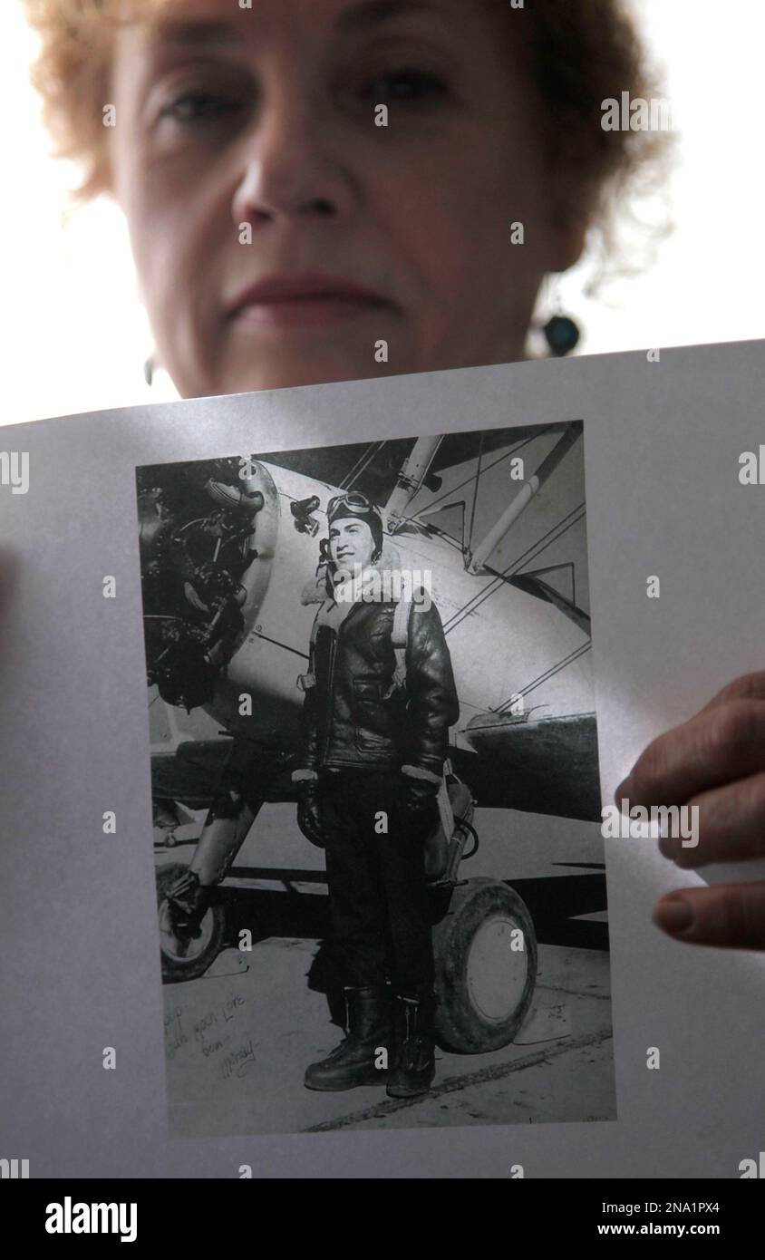 Andrea Talbutt holds a photo of her "Uncle Mike" at her home in ...