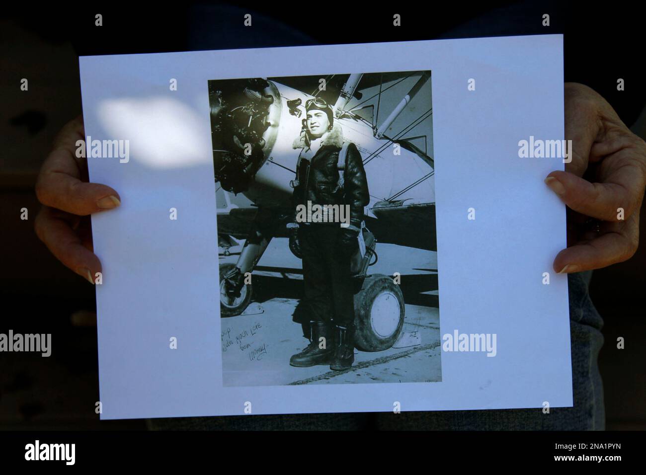 Andrea Talbutt holds a photo of her "Uncle Mike" at her home in ...
